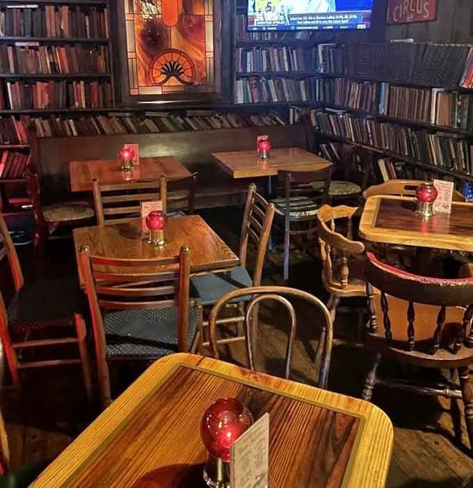 Mismatched tables and chairs surrounded by books create an atmosphere where everyone feels like a regular.