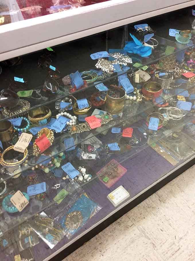 Vintage jewelry sparkling behind glass like a pirate's treasure chest, minus the map and the questionable hygiene.