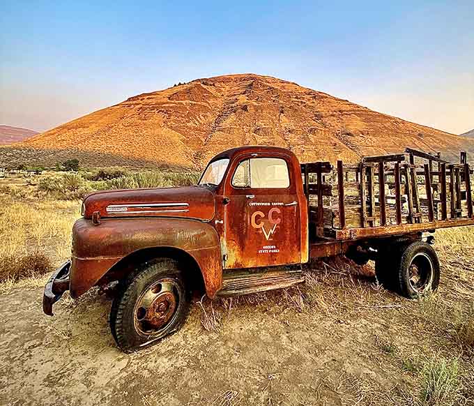 This weathered ranch truck has seen better days but still commands respect against that stunning backdrop.