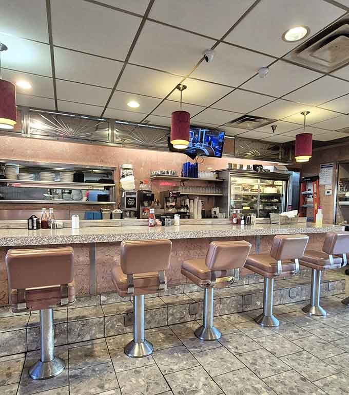 Counter seating where you can watch the kitchen work its magic while your coffee stays perpetually full.