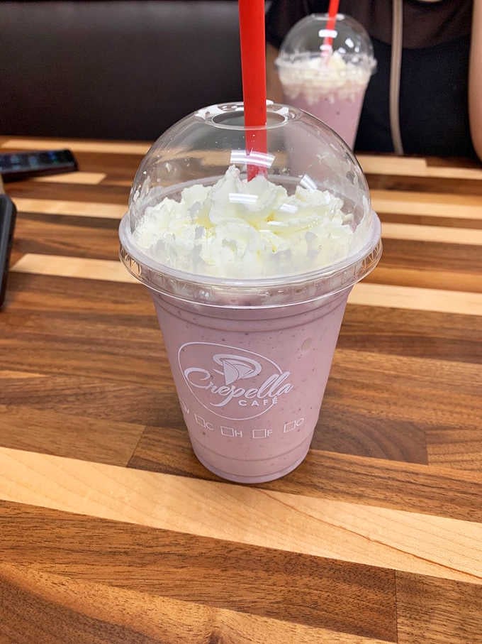 That pink smoothie topped with whipped cream is basically a milkshake pretending to be healthy, and we're here for it.