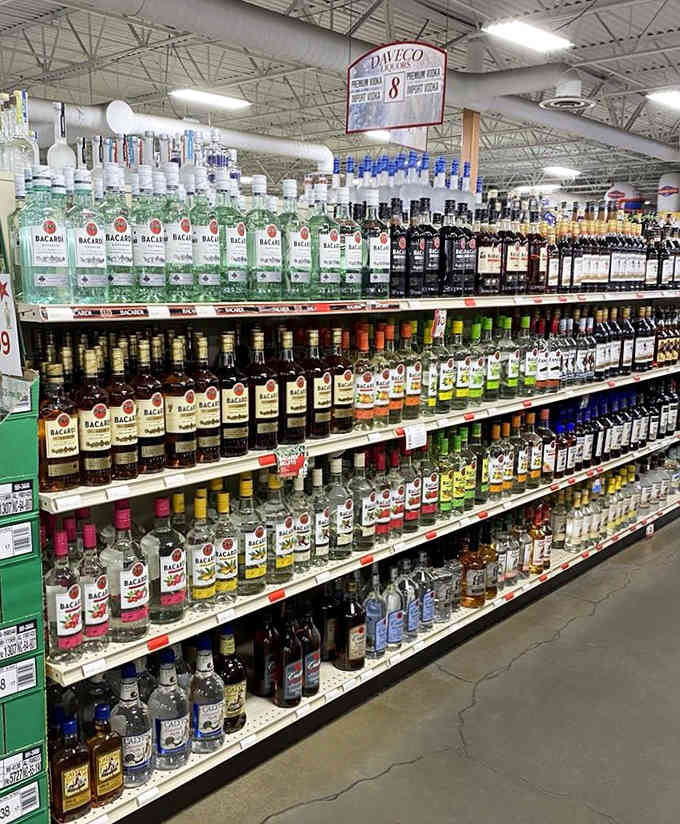 Rum shelves stacked high with Caribbean dreams and tropical possibilities, all waiting to transform your next cocktail hour completely.
