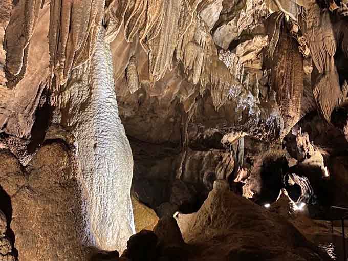 Massive flowstone formations cascade down the walls like frozen waterfalls, creating one of nature's most impressive artistic displays.