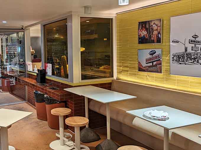 Bright yellow walls and vintage photos create a cheerful atmosphere that makes every meal feel like a celebration.