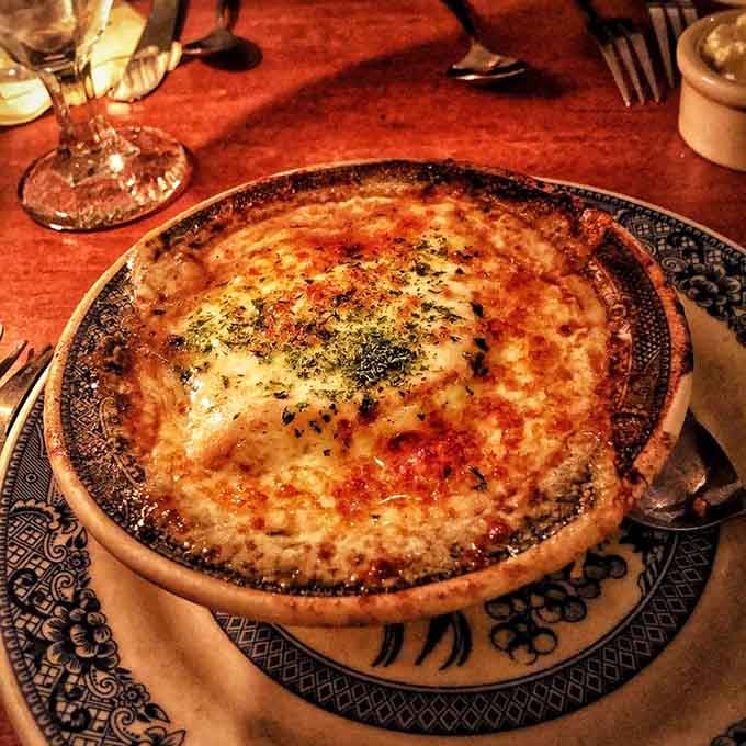 Baked onion soup arrives bubbling like a delicious science experiment you actually want to taste immediately.