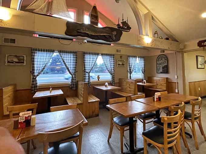 Cozy booth seating with model ships overhead, creating the perfect spot for families and seafood lovers alike.