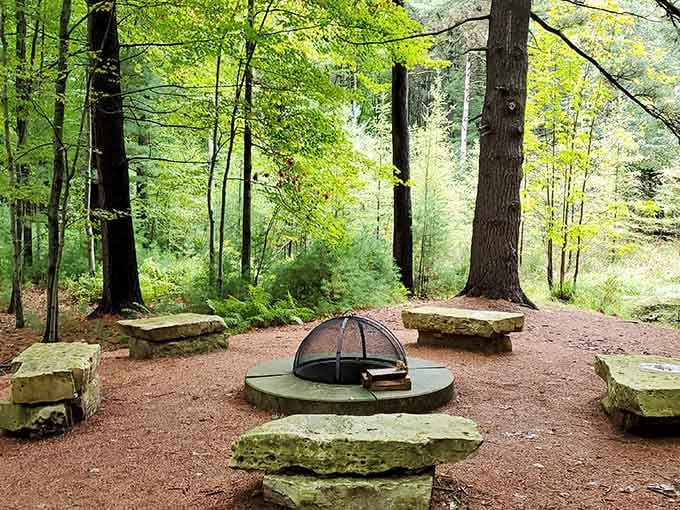 Stone benches circle a fire ring in the forest, creating the ultimate spot for campfire stories and s'mores.
