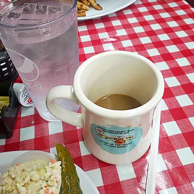 Coffee in a classic mug on checkered cloth, because some mornings require the simple pleasure of a good cup and nothing more.