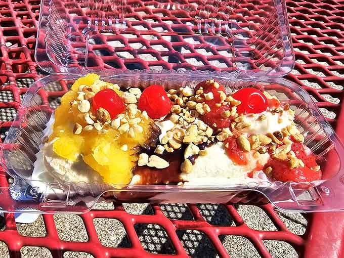 The classic banana split arrives in a plastic container, proving fancy presentation can't compete with generous portions.