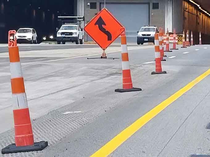 Orange cones remind you that even tunnels through mountains need occasional tune-ups and careful attention from dedicated workers.