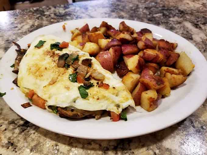 A veggie-packed omelet with perfectly seasoned home fries shows breakfast doesn't have to be boring to be satisfying.