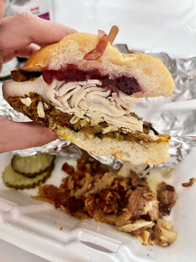 The turkey gobbler sandwich stands tall with layers of turkey, stuffing, and cranberry sauce on a grinder roll.