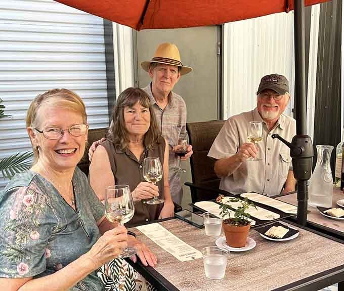 Happy visitors raising their glasses to good wine, great views, and even better company.