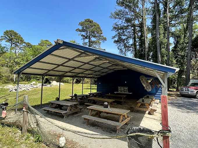 Covered picnic tables under metal roofing provide the perfect spot to devour your seafood feast in comfortable shade.