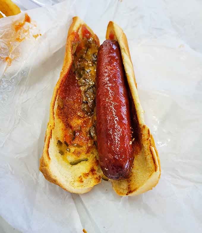 A hot dog that's been elevated beyond its ballpark origins into something genuinely worth celebrating here.