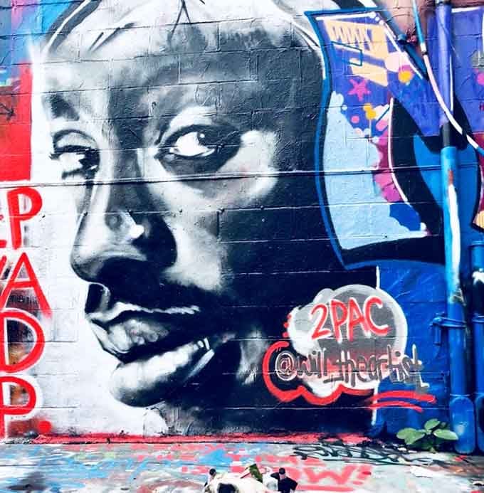A powerful tribute rendered in striking black and white, proving that street art can honor legends with genuine reverence.