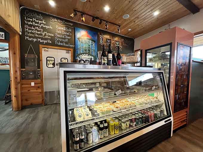 The dessert case beckons with sweet temptations while the chalkboard menu promises savory delights and creative cocktails.