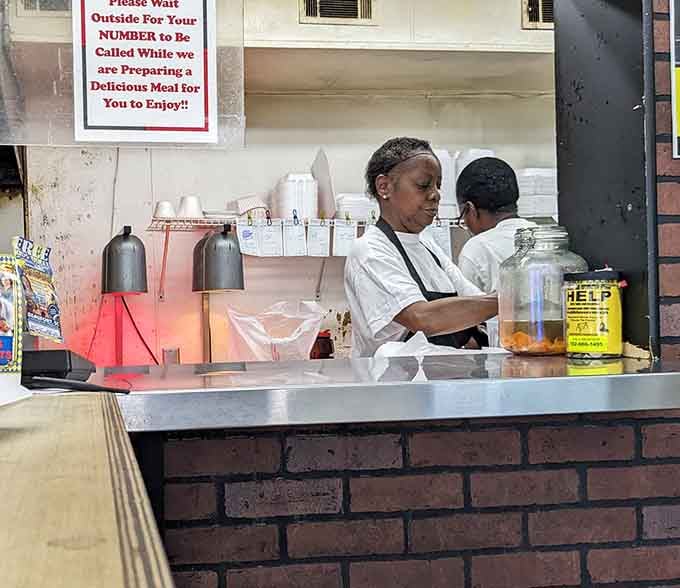Behind that window, dedicated hands are creating the kind of food that keeps people coming back for decades.