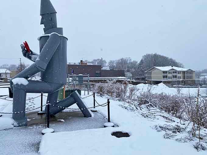 Winter transforms the scene into a snow globe moment, with the Tin Man standing guard over the frozen landscape.