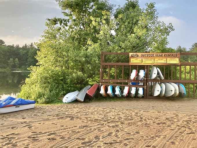 Kayaks and paddleboards waiting patiently to transform landlubbers into temporary water explorers for the day.