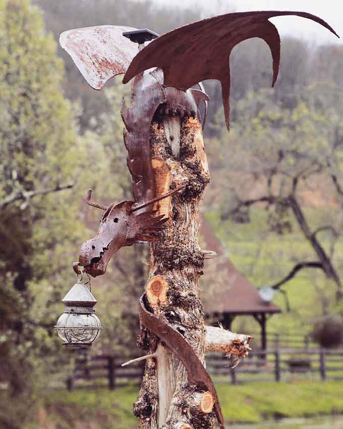 A metal dragon sculpture perched on weathered wood adds just the right touch of fantasy danger.