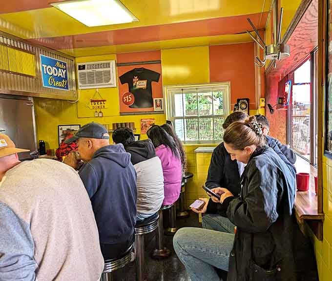 A full counter of happy diners at various stages of breakfast bliss, the universal language of good food.