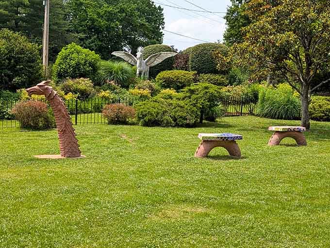 Simple stone benches and a chess piece await visitors seeking a quiet moment in this enchanted corner of the park.
