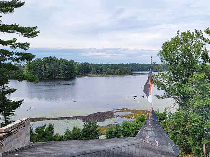 The tower view reveals pristine lake waters stretching toward distant shores, a vista any medieval lord would envy.