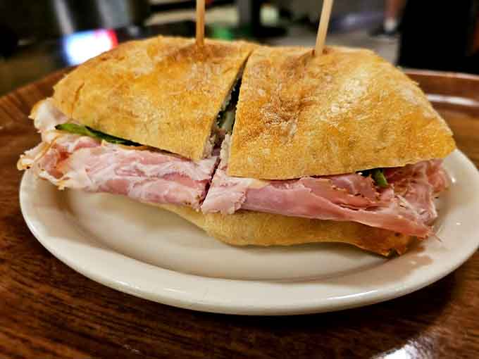 House-made porchetta on fresh bread proves that simple ingredients plus skill equals pure magic on a plate.