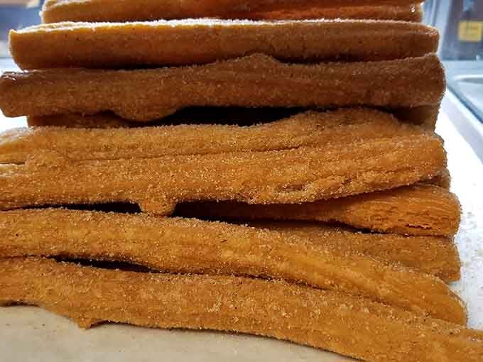 A stack of churros so perfectly golden and cinnamon-dusted, they deserve their own standing ovation.