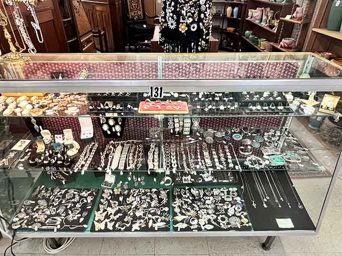 Sparkling vintage jewelry displayed like treasure in a pirate's cave, each piece waiting to adorn someone special again.