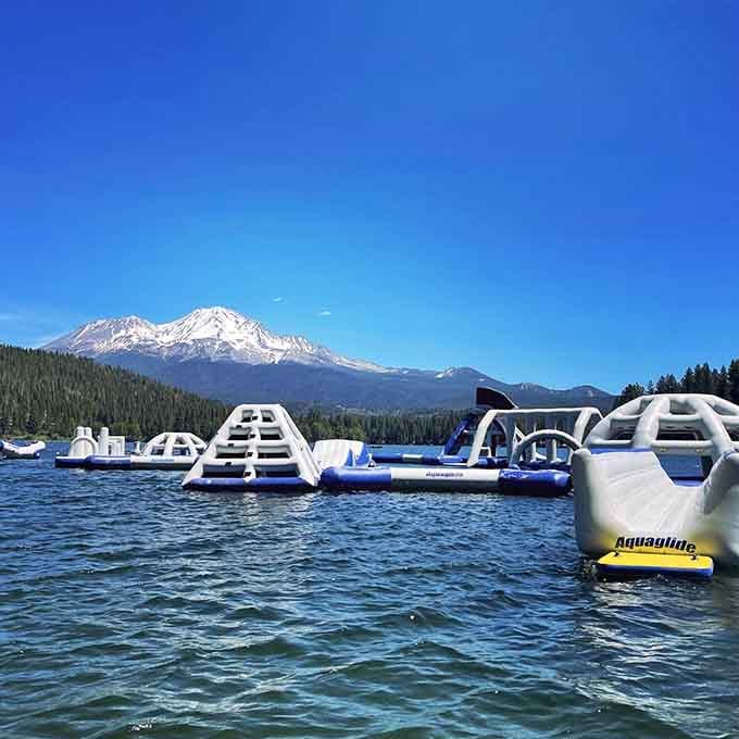 White inflatable pyramids dot the blue water like someone scattered giant marshmallows across the lake's surface perfectly.