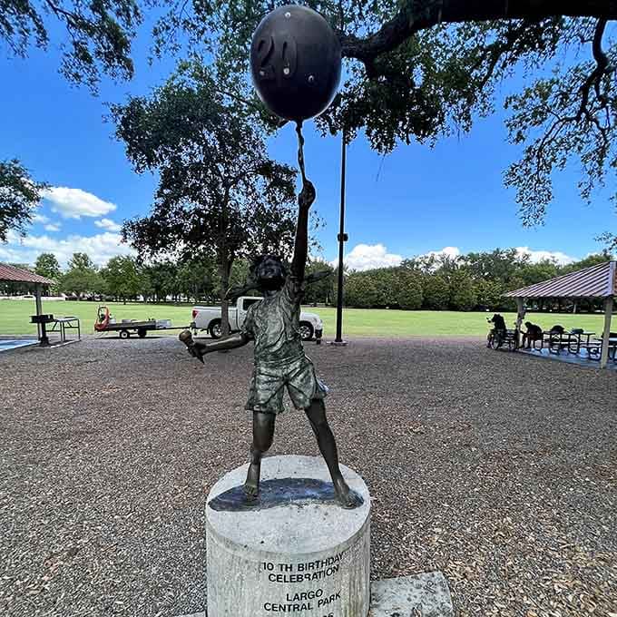 This whimsical bronze child clutching a balloon captures the pure wonder every visitor feels stepping into this magical space.