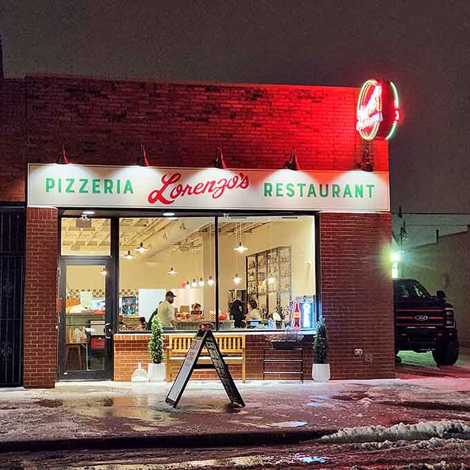 Lorenzo's glowing sign beckons like a beacon of hope for anyone craving authentic pizza without mortgage-level prices.