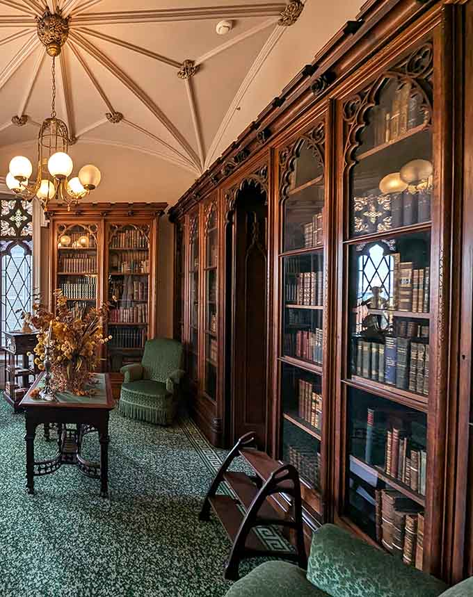 A library with built-in bookcases and Gothic details that would make Belle from Beauty and the Beast weep with joy.