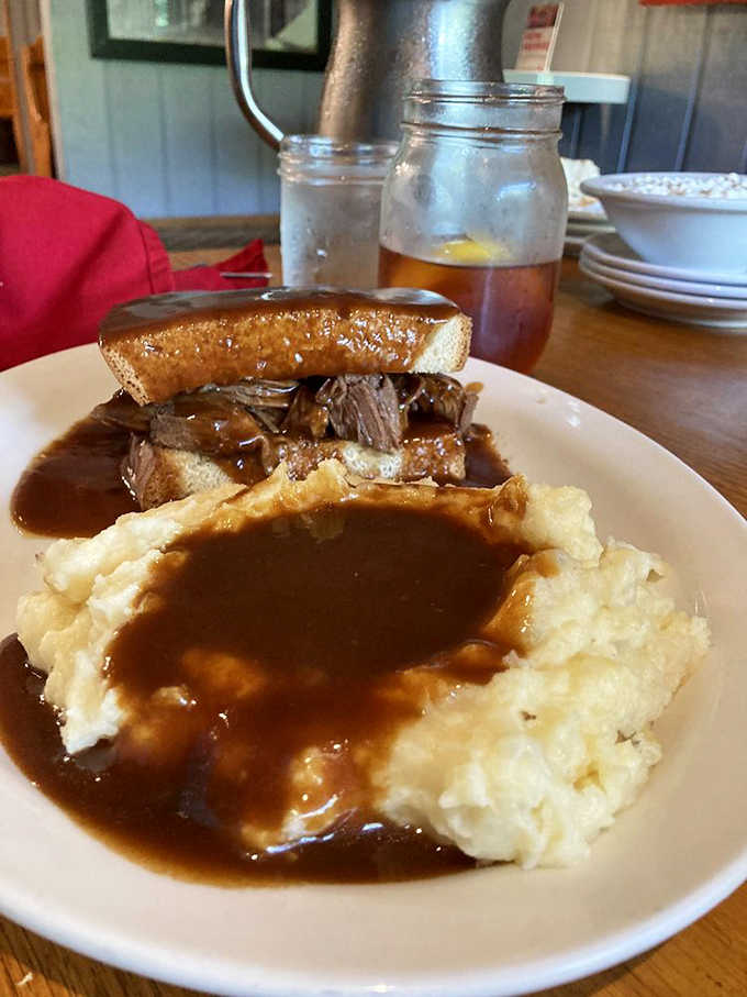 Pot roast so tender it's practically falling apart, sandwiched between Texas toast and swimming in gravy.
