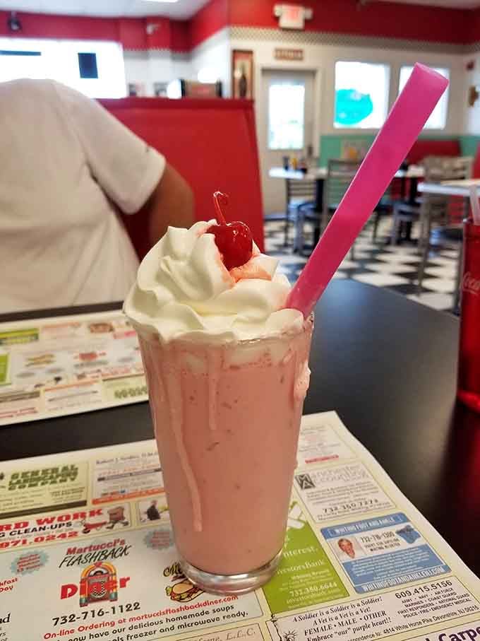 A strawberry shake crowned with whipped cream and a cherry, because some traditions deserve to live forever.