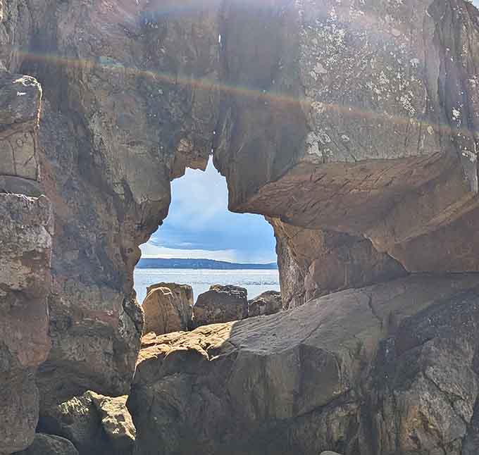 A natural window in the rock frames the sea beyond. Instagram wishes it could filter this well.