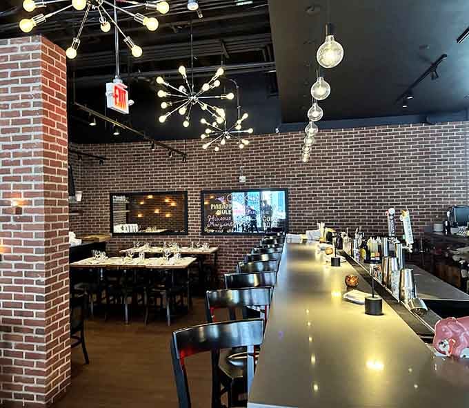 The bar area features modern lighting and a chalkboard cocktail menu that's almost as appealing as the drinks.