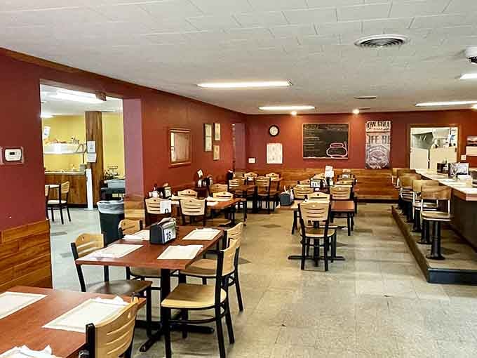 Booth seating stretches through connected rooms, accommodating everyone from solo diners to entire family reunions seeking comfort.