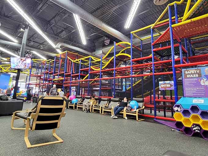 The sprawling seating area with colorful tables proves someone understood that parents need comfortable observation posts with good sightlines everywhere.