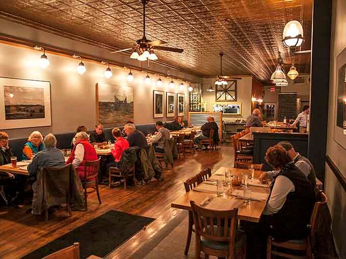 Tin ceilings and vintage fixtures setting the scene for conversations that last longer than the meal itself.