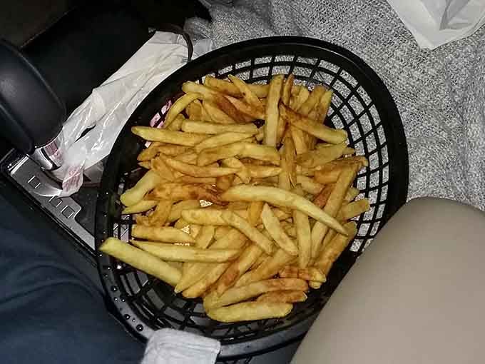 A basket of perfectly golden fries proves that some things don't need improvement, just appreciation and ketchup.