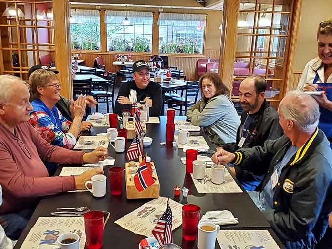 Regulars gathering around the table, sharing stories and probably debating their favorite pie flavors endlessly.