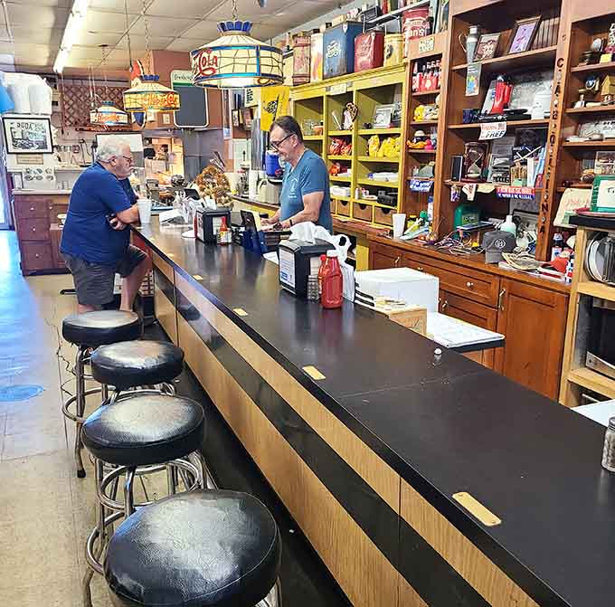 Counter stools lined up like soldiers, ready to support anyone seeking good food and better conversation all day.