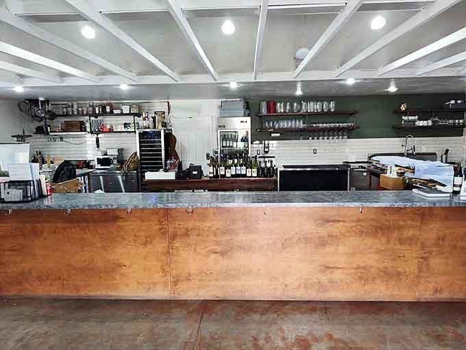Clean lines and copper accents create a tasting room that feels both modern and warmly inviting simultaneously.