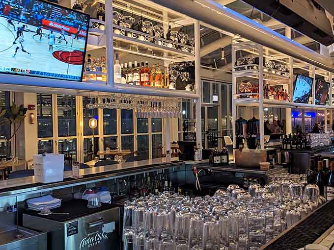 That gleaming bar setup with its wall of glassware practically begs you to pull up a stool and stay awhile.