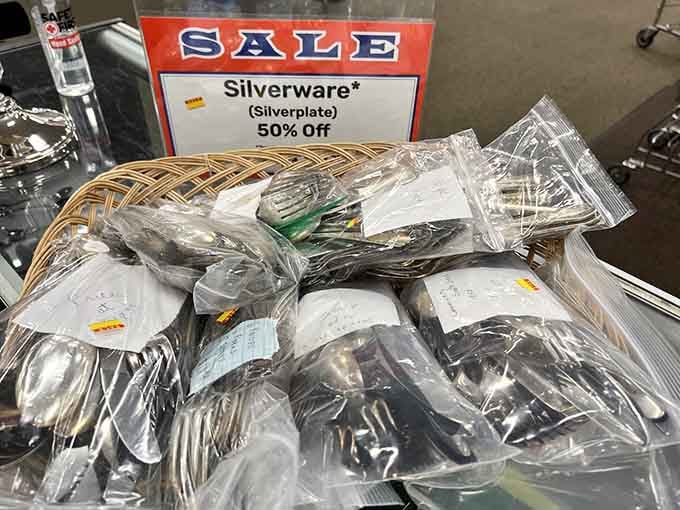 Silverware sets at half price, because even thrift store shoppers deserve to set a proper table for Sunday dinner.