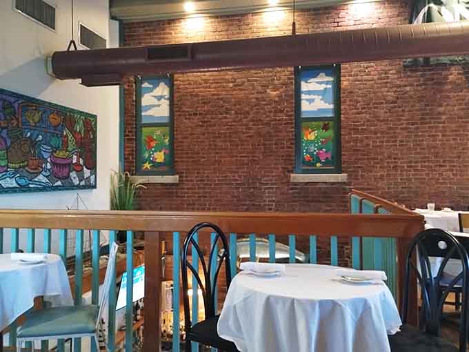Upper level seating with those timber beams overhead makes every meal feel like a special occasion worth celebrating.