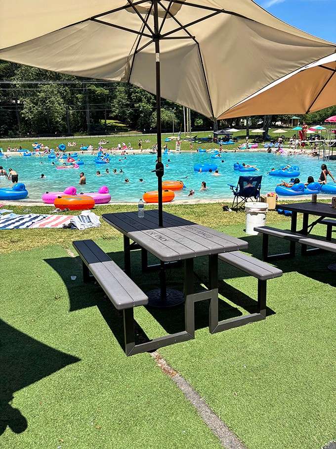 Umbrellas providing shade while colorful floats dot the water like a summer postcard come alive.